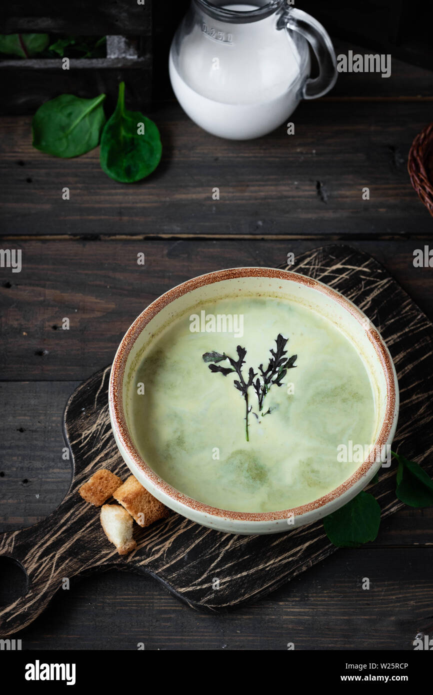 Creamy soup puree with spinach on a dark background Stock Photo - Alamy