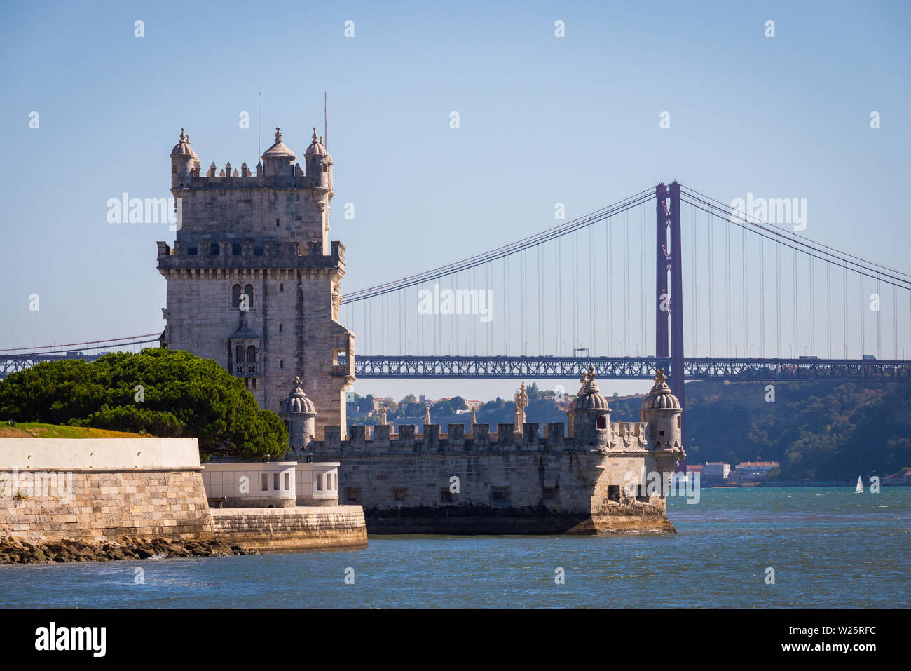 Scenic Belem Tower and wooden bridge miroring with low tides on Tagus ...
