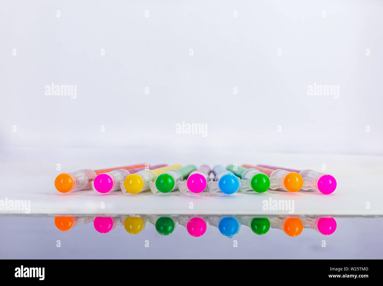 Set of colored pens and its reflection white background Stock Photo - Alamy