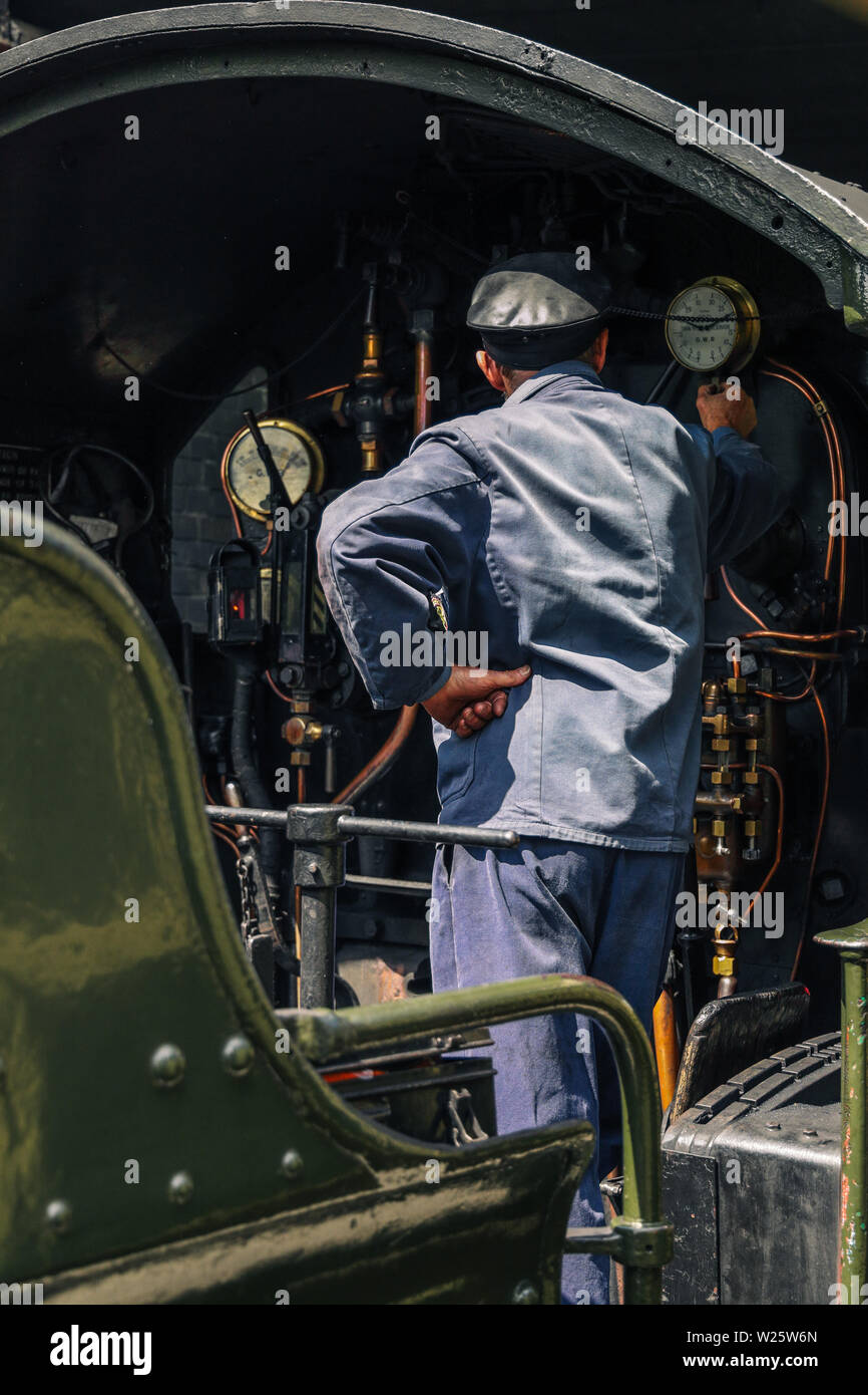 Driver on a heritage railway vintage steam train Stock Photo - Alamy