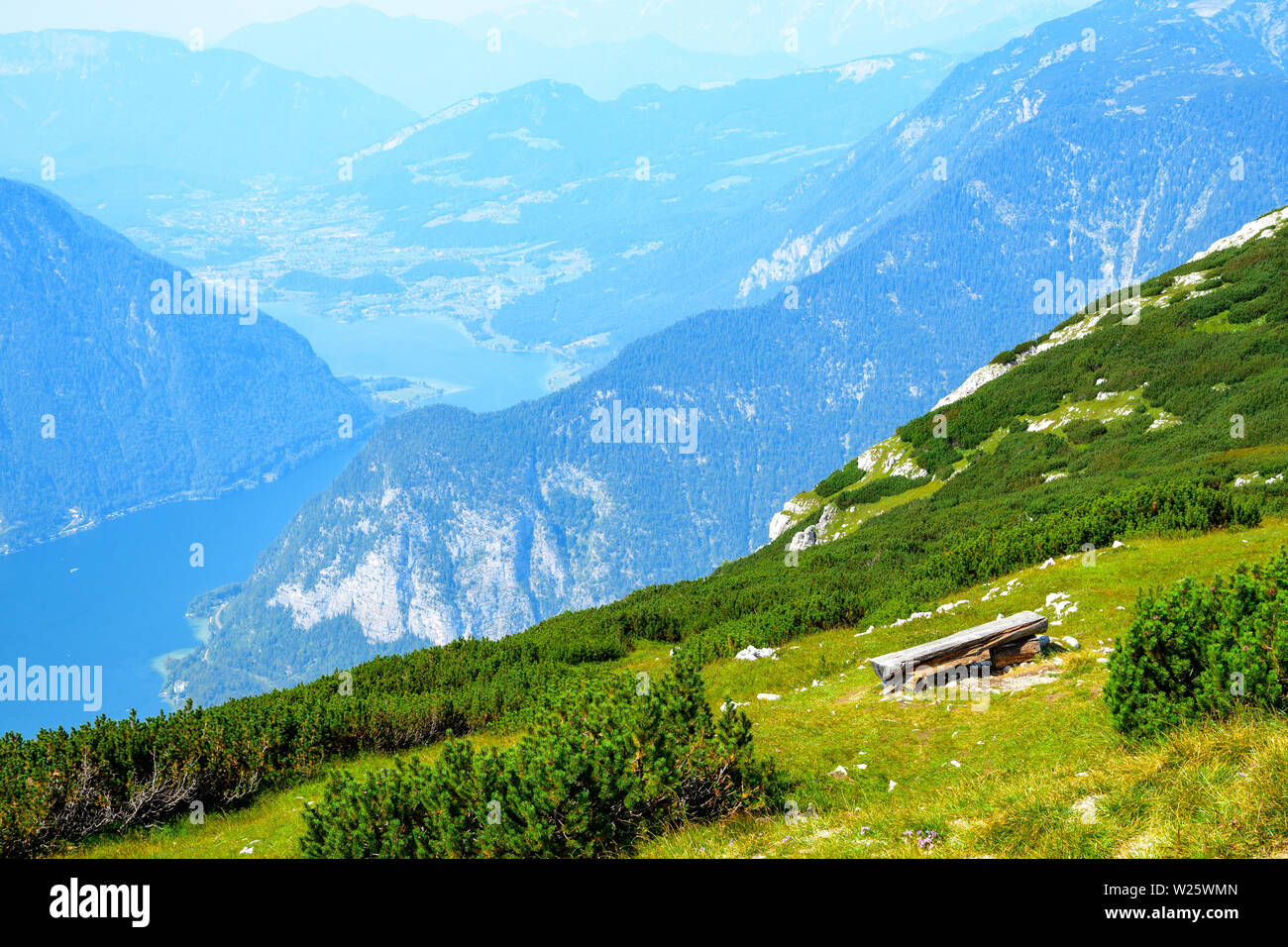Bench on the slope of a high mountain in the Austrian Alps overlooking ...