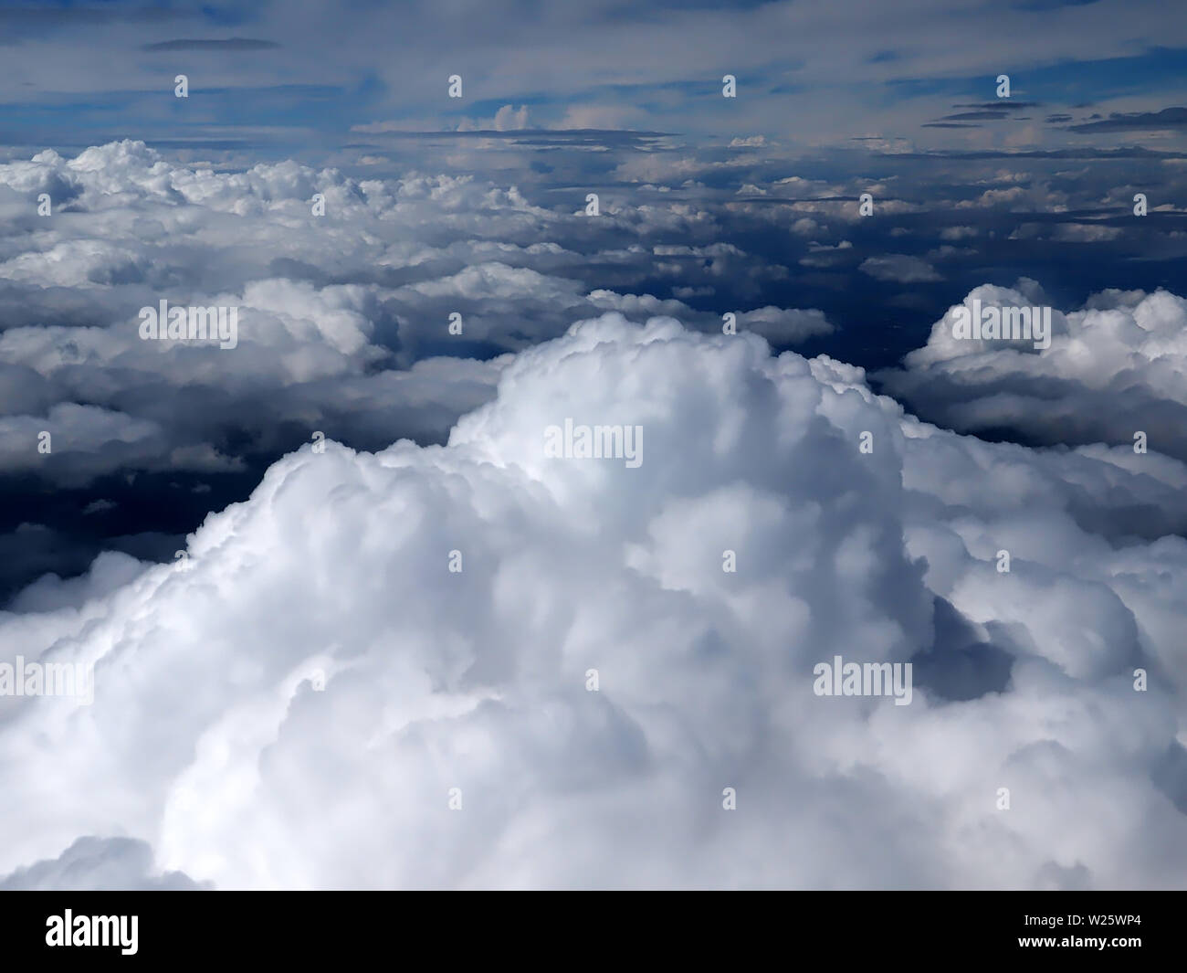 Aerial view of clouds at the sky seen on a flight with an airplane ...
