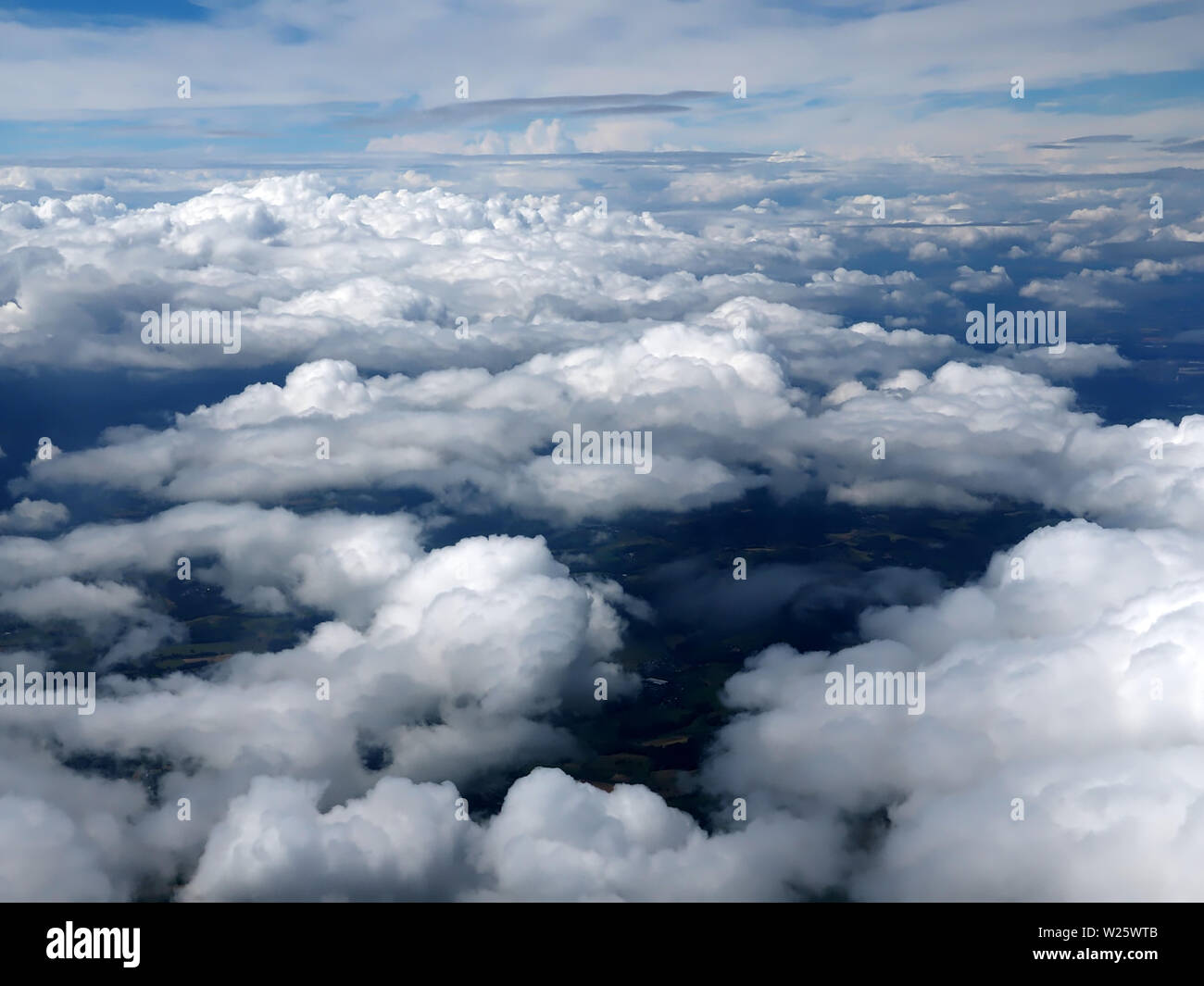 Aerial view of clouds at the sky seen on a flight with an airplane ...