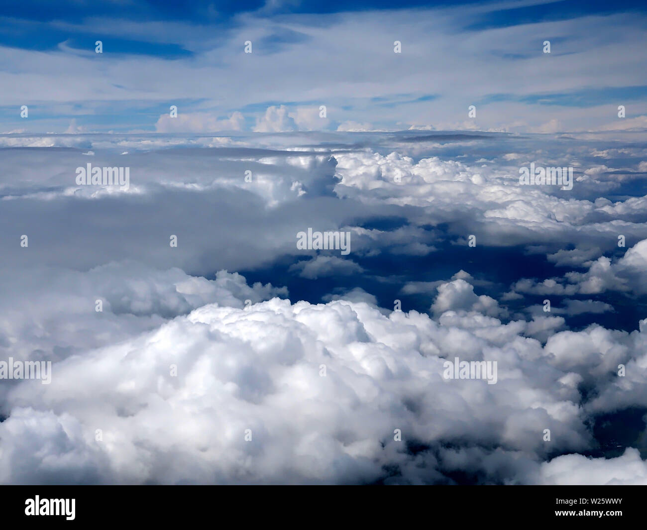 Aerial view of clouds at the sky seen on a flight with an airplane ...