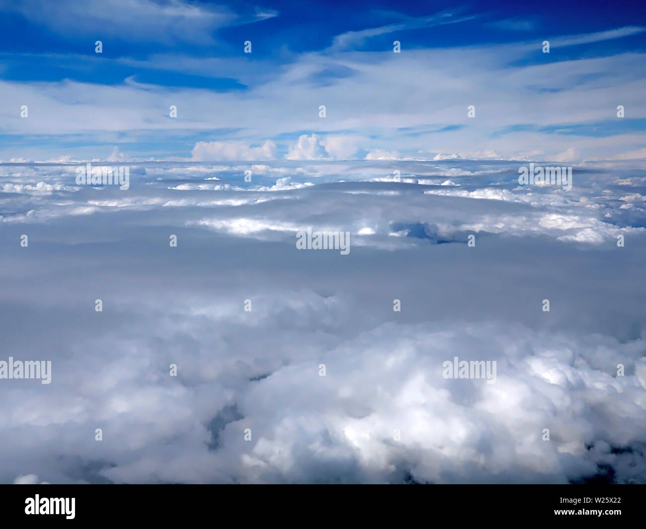Aerial view of clouds at the sky seen on a flight with an airplane ...
