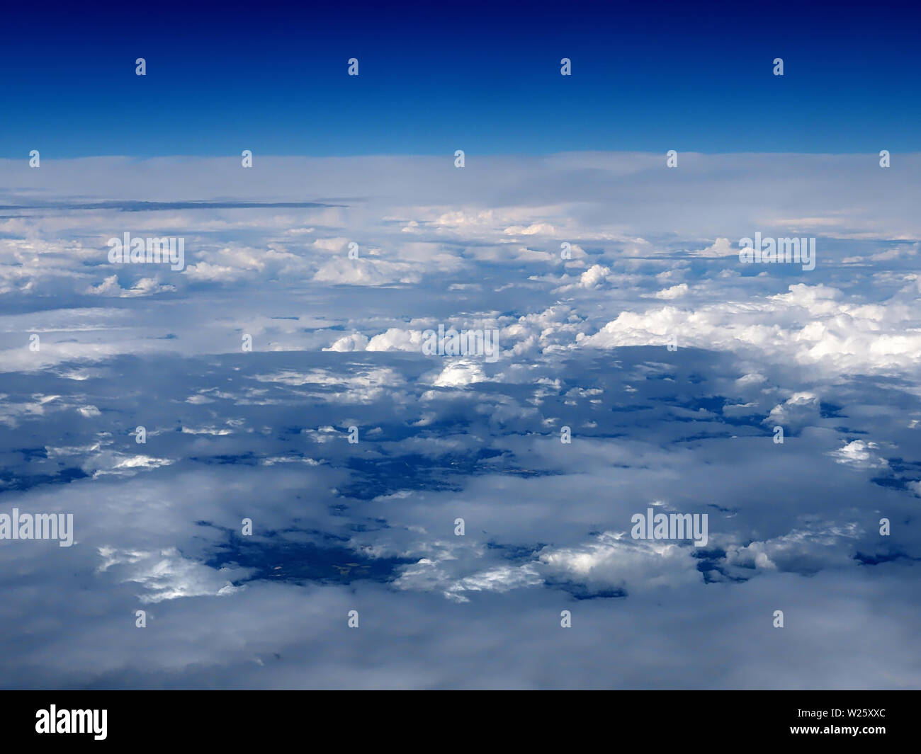 Aerial view of clouds at the sky seen on a flight with an airplane ...