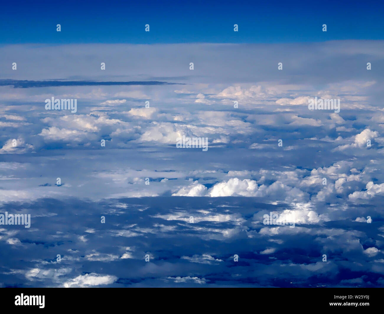 Aerial view of clouds at the sky seen on a flight with an airplane ...