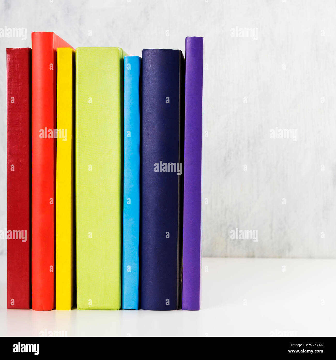 Stack of colorful rainbow books on white background. Copy space Stock ...
