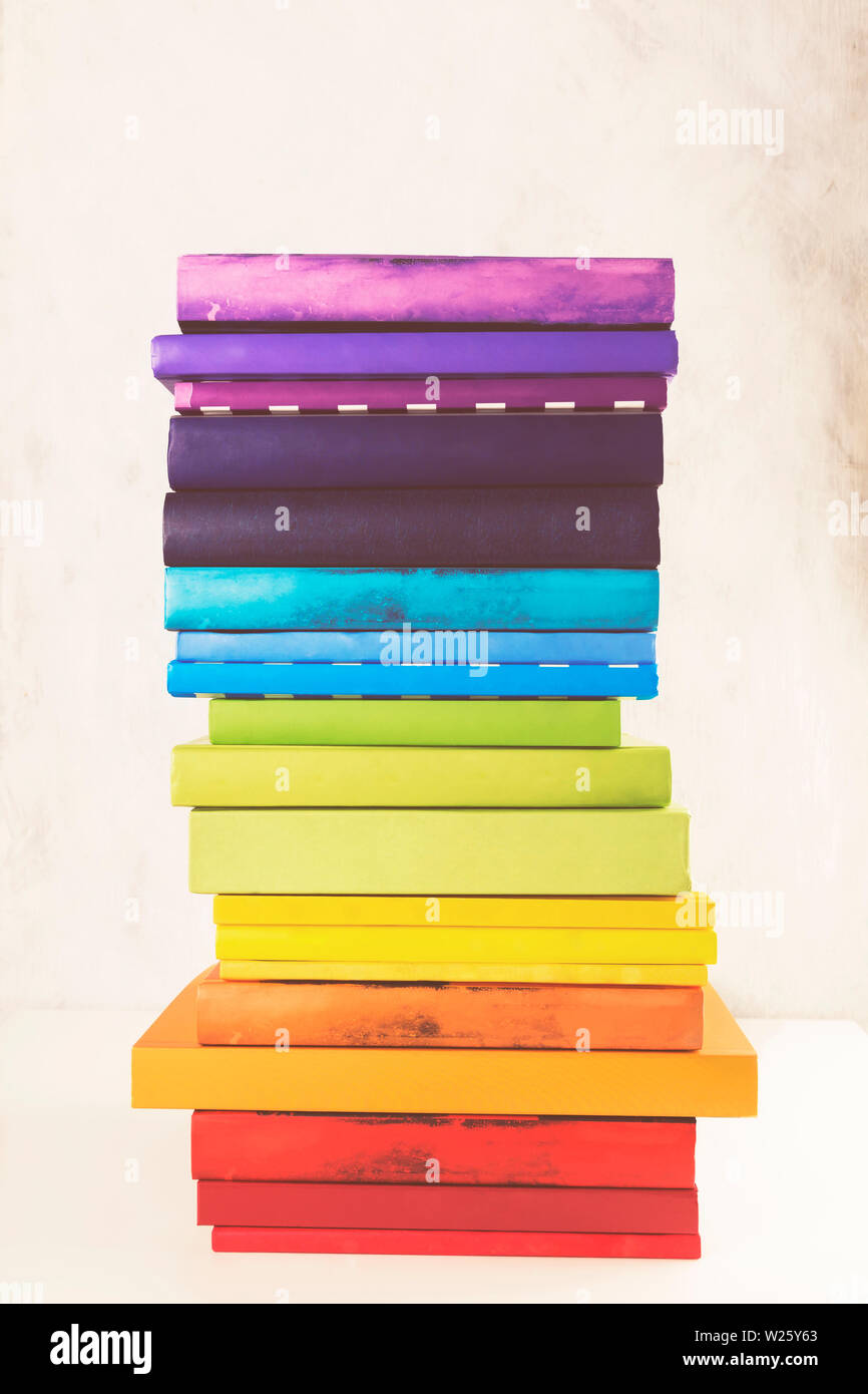 Stack of colorful rainbow books on white background. Toned Stock Photo ...