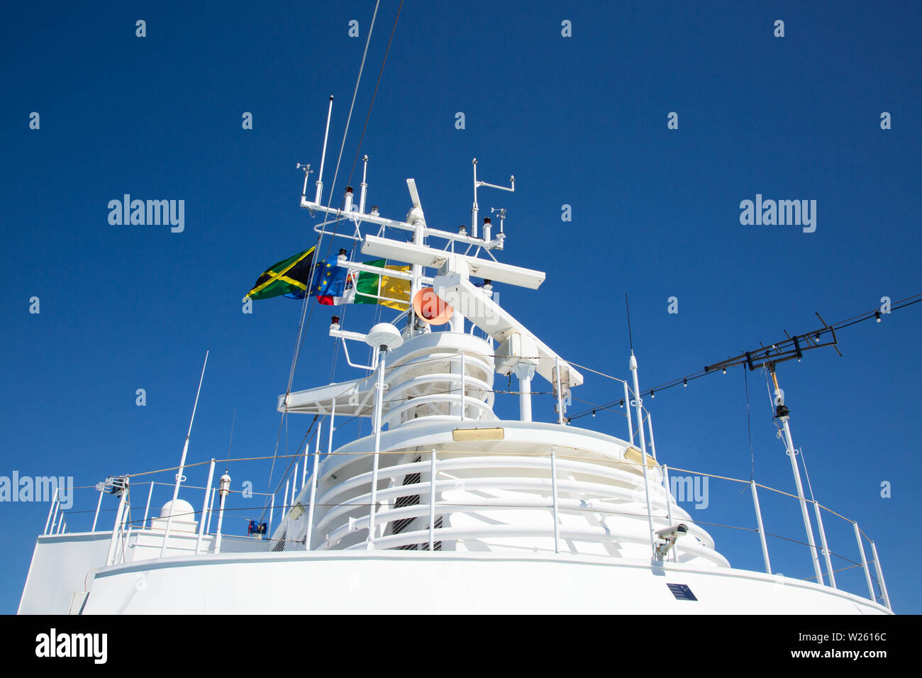 Navigation equipment and masts of cruise ship decorated with flags ...