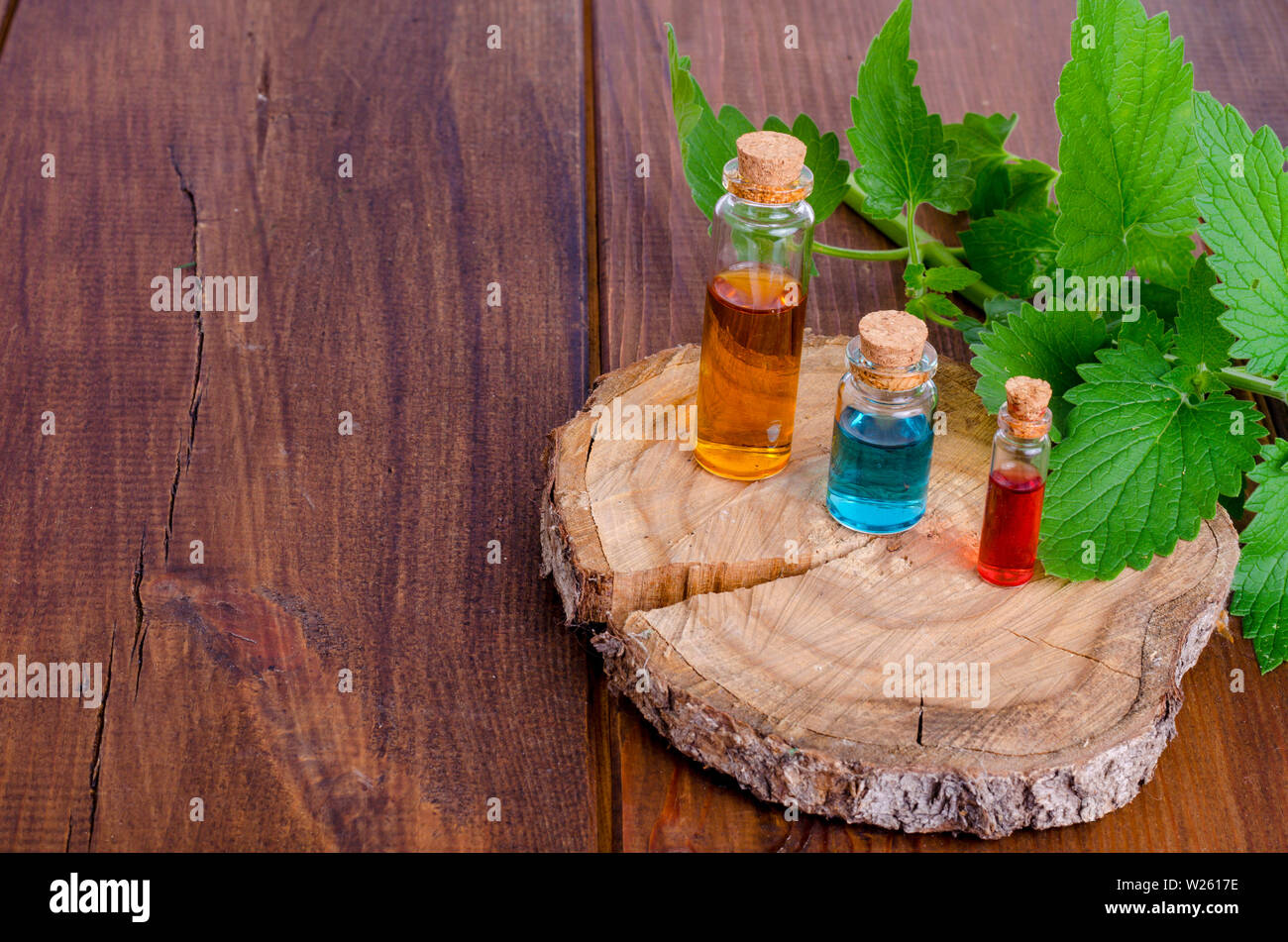 Glass bottles of aroma essential oil on wooden background, image for ...