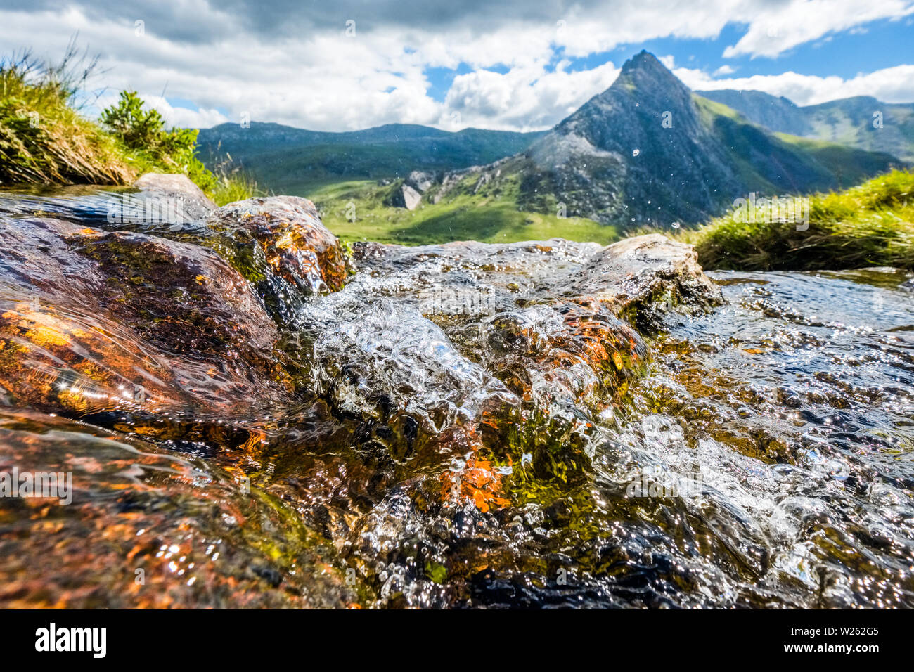 Mountain stream with Tryfan mountain in background. Snowdonia, North ...