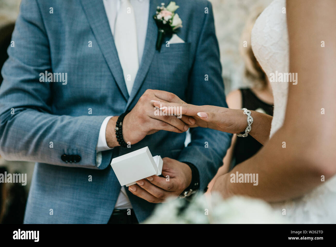 The groom or husband puts the ring on the bride or wife of the wedding ...