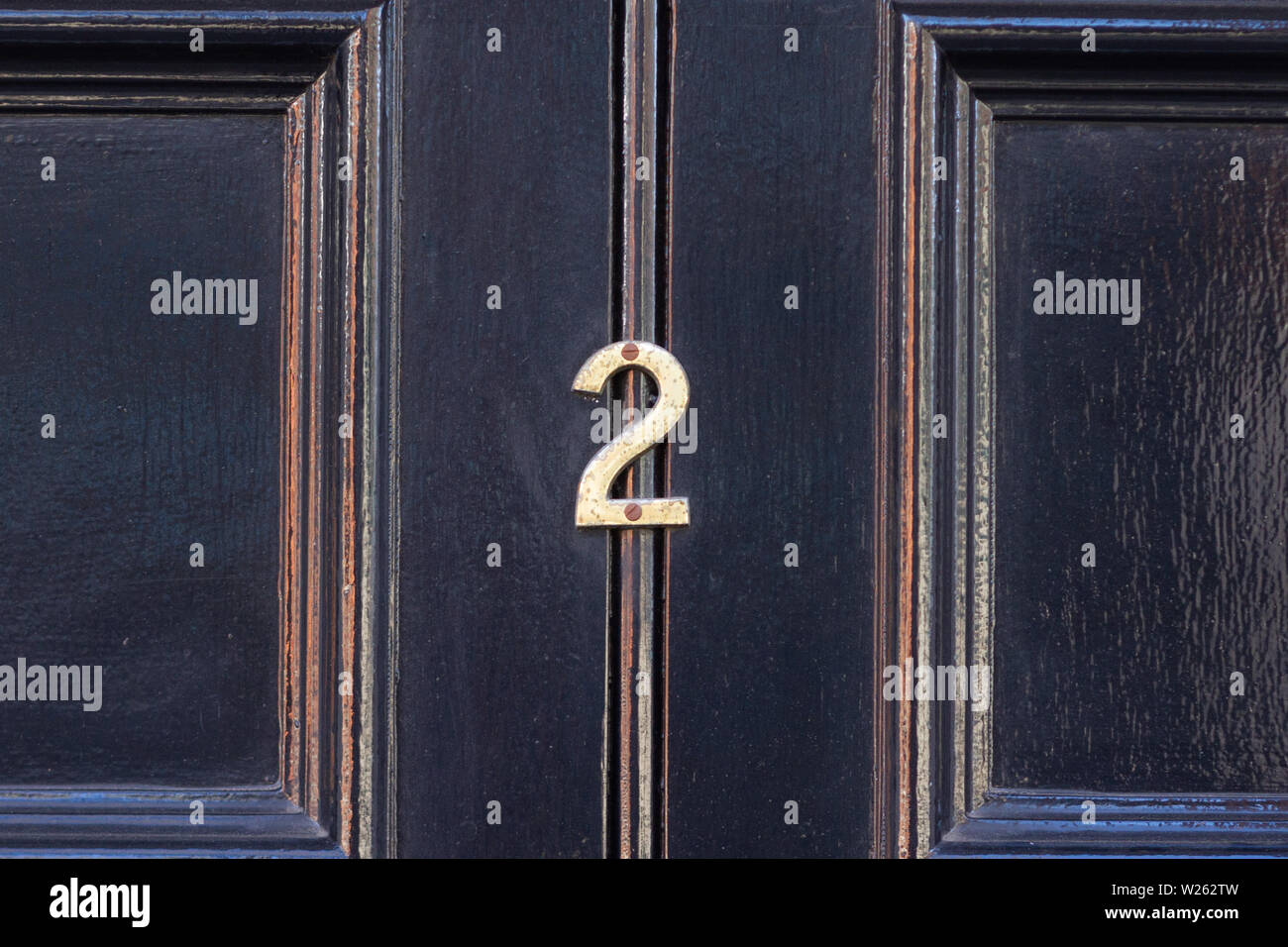 House number two with the 2 in metal digits on a black wooden front ...