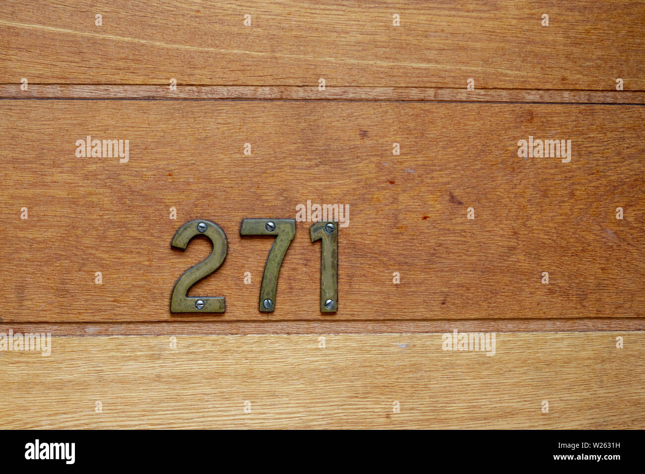 House number 271 with the 271 in metal digits on a natural grained ...