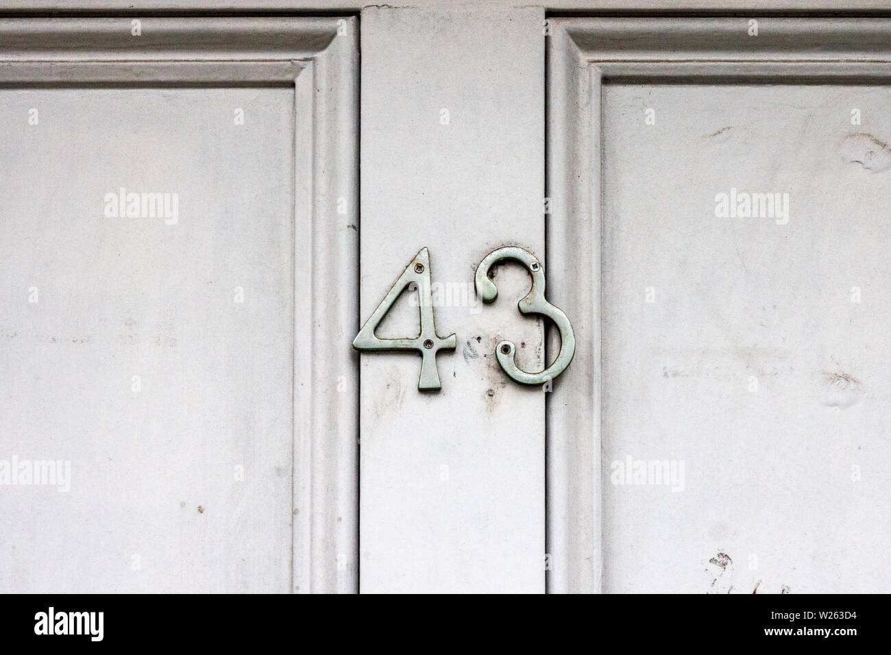 House number 43 with the forty-three in crooked metal digits on a white ...