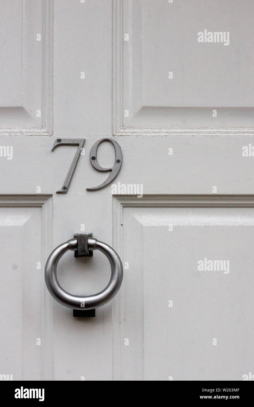 House number 79 with the seventy-nine in metal digits on a wooden front ...