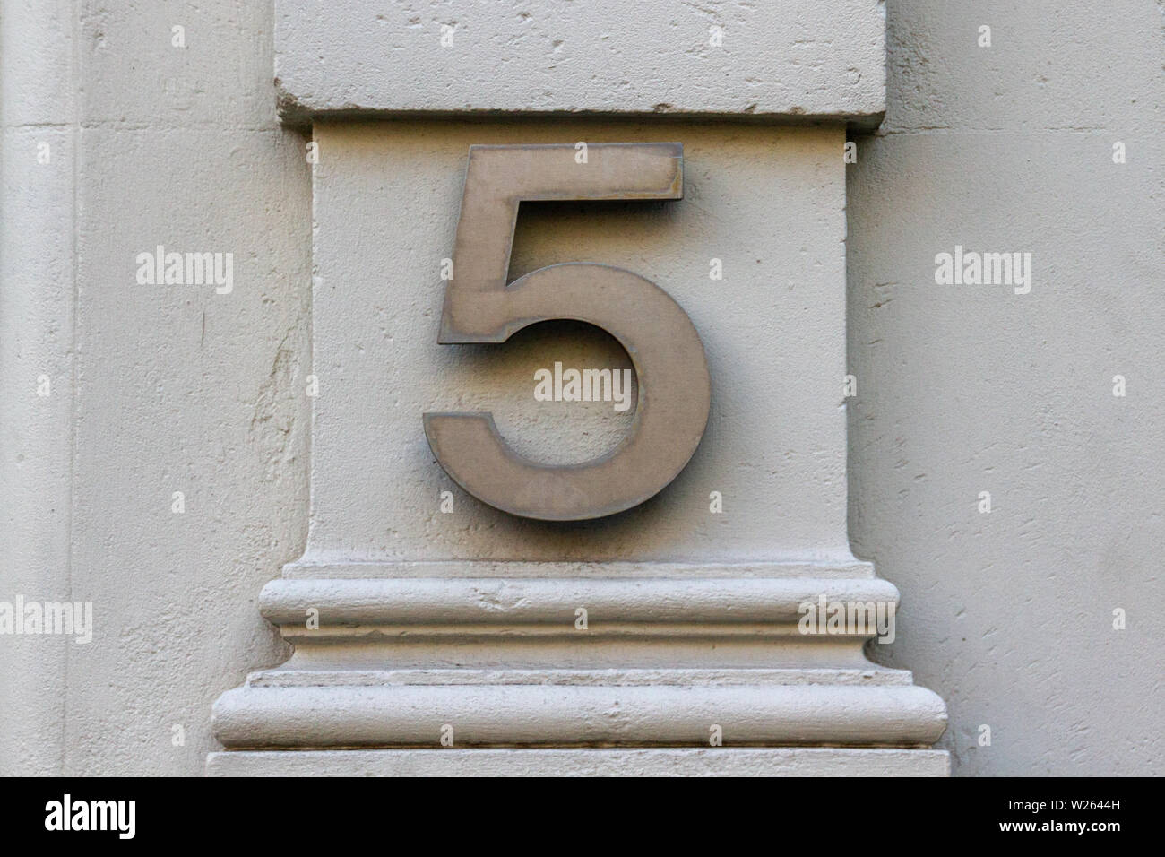 House number 5 with the five in silver brushed metal on a pillar Stock ...
