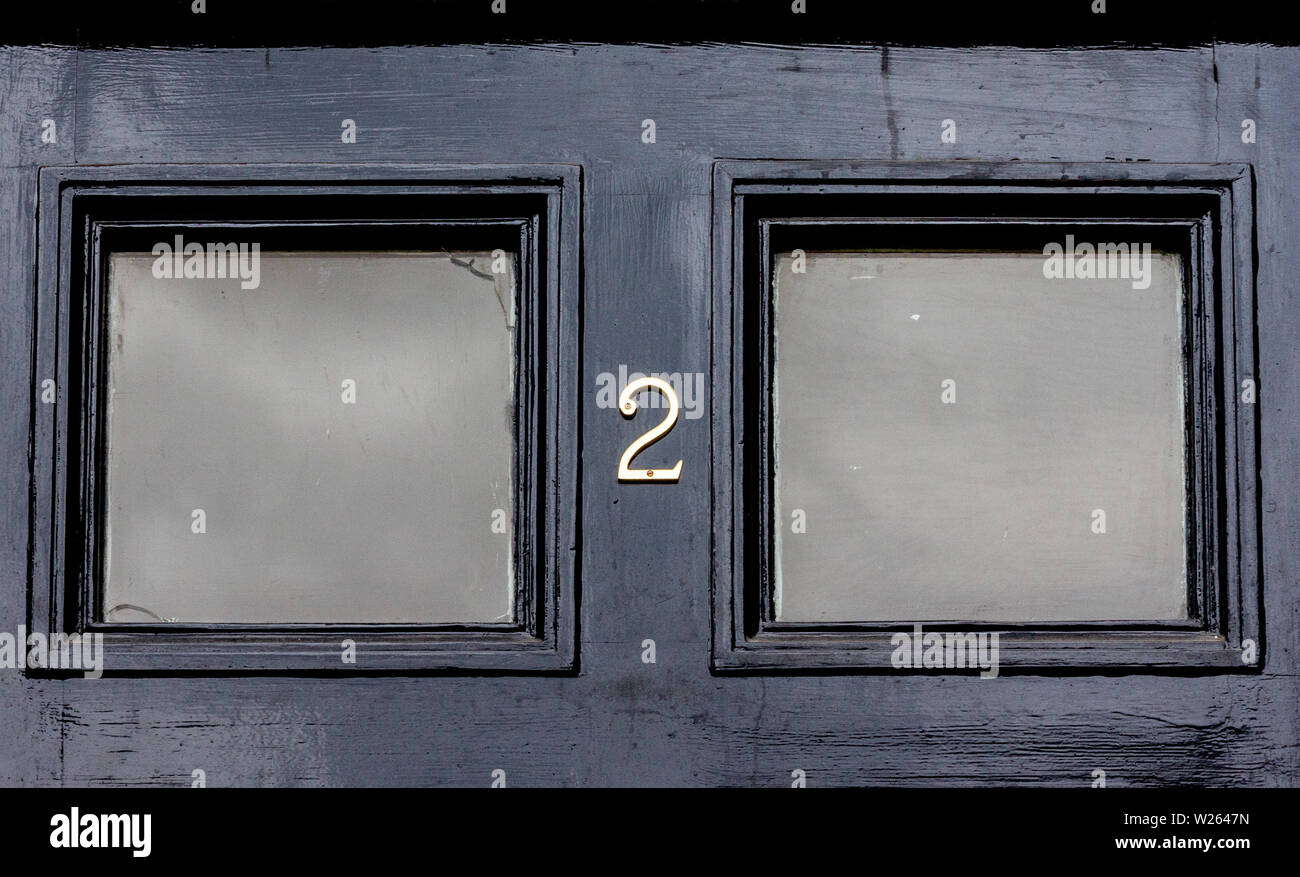 House number 2 with the two in metal digits on a wooden front door ...