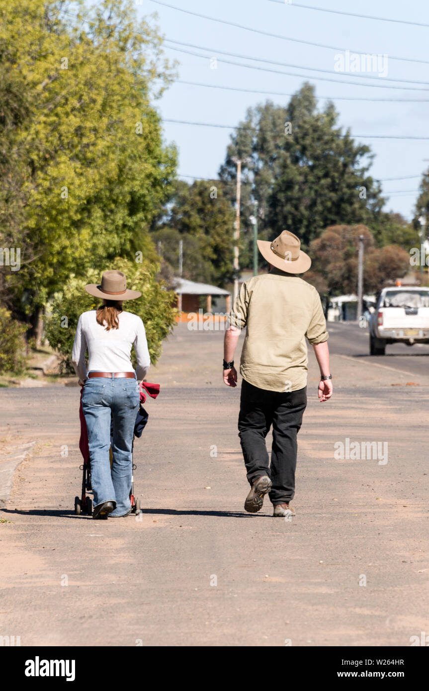 A couple wearing typical Australian hats in a small country town of ...