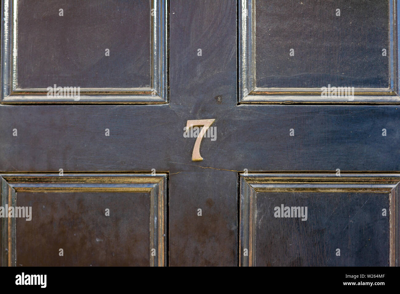 House number 7 with the seven in metal digits on a wooden front door ...