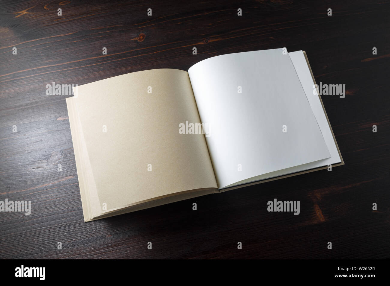 Blank open booklet on wooden background. Responsive design template ...