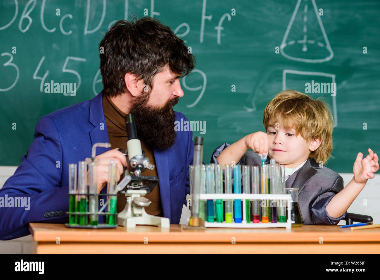 Back to school. father and son at school. school kid scientist studying ...