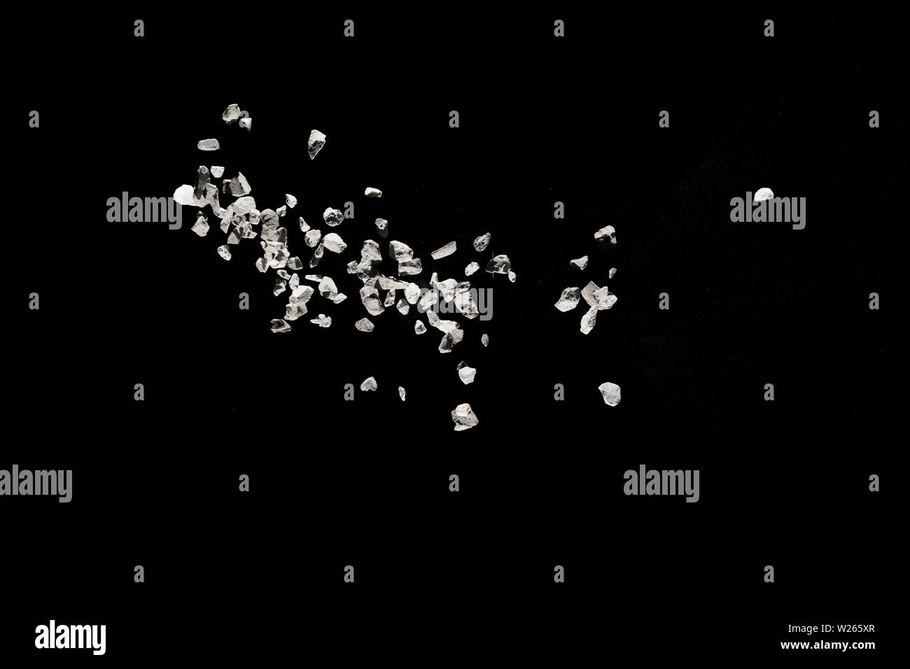 Split debris of stone exploding against black background Stock Photo ...