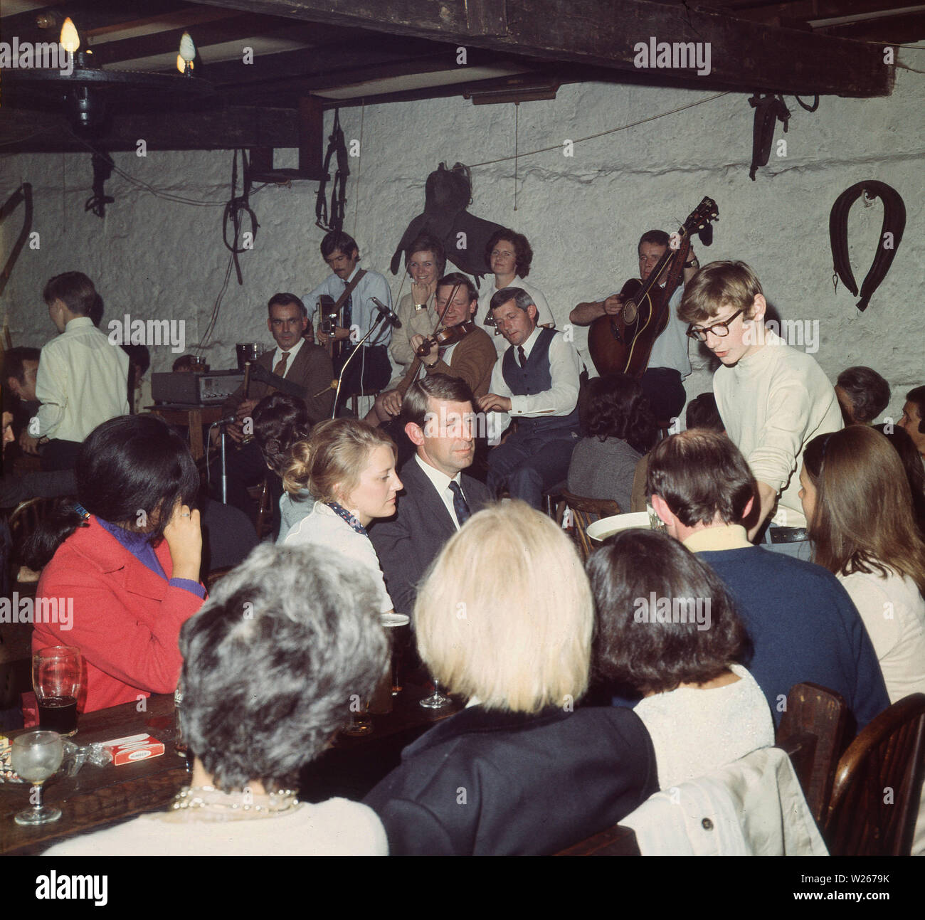 1960s, historical, In a Irish country pub, Ireland, people enjoying a ...