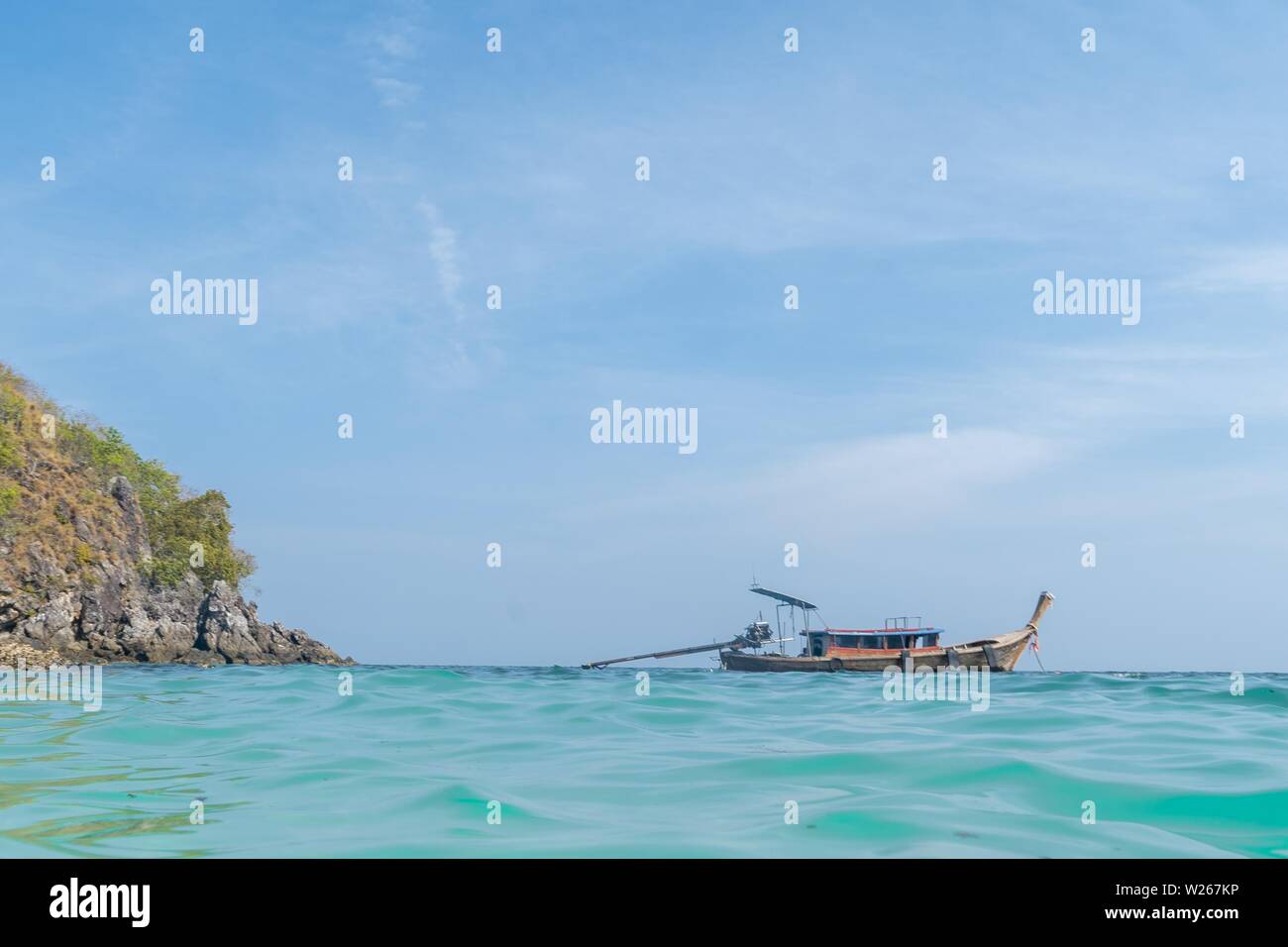 Long range shot an old wooden oriental ship close to an island with ...