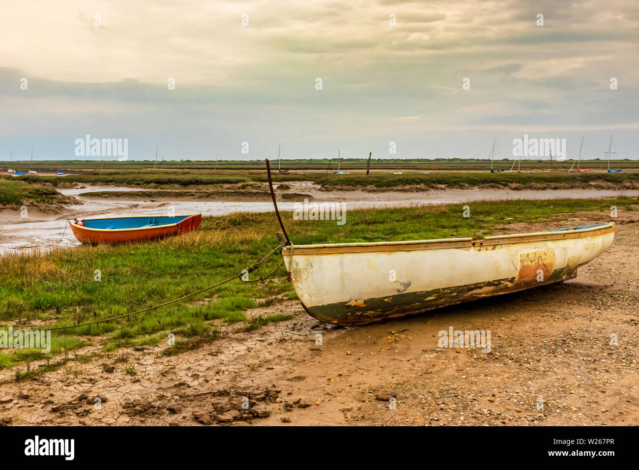 Small traditional wooden fishing boats on mudflats overlooking the ...