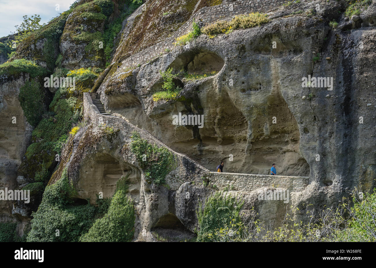 Meteora, Greece - April 2019 : People climbing stairs cut in a rock to ...