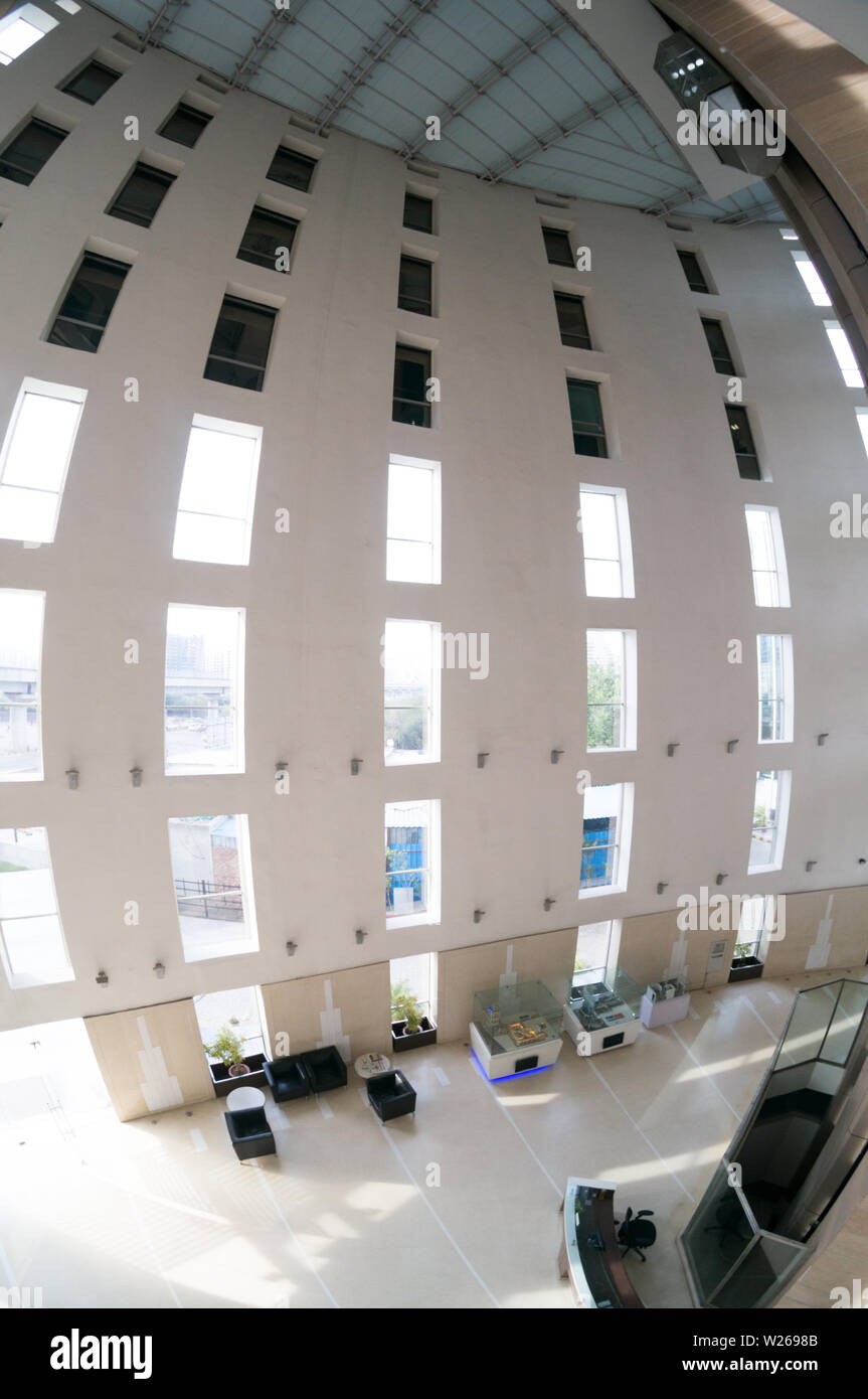 Fisheye shot of atrium of office with tall pillars and a huge open ...