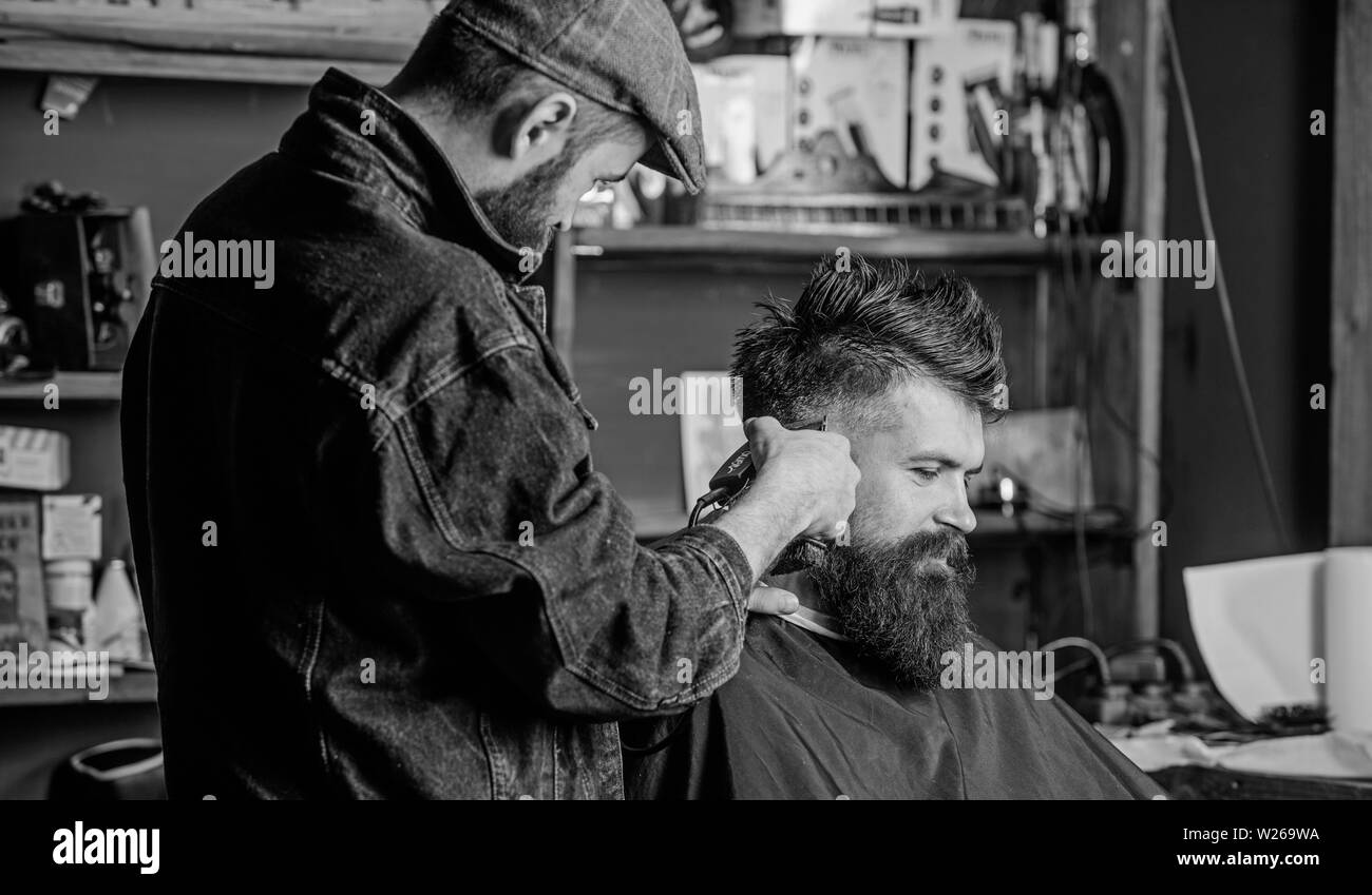 Hipster lifestyle concept. Hipster client getting haircut. Barber with ...
