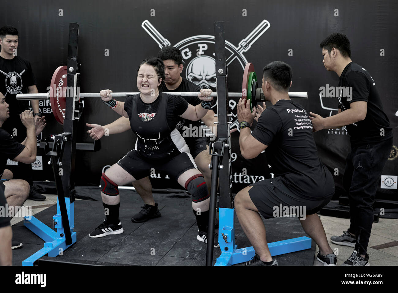 Power lifting female competitor participating in a weightlifting ...