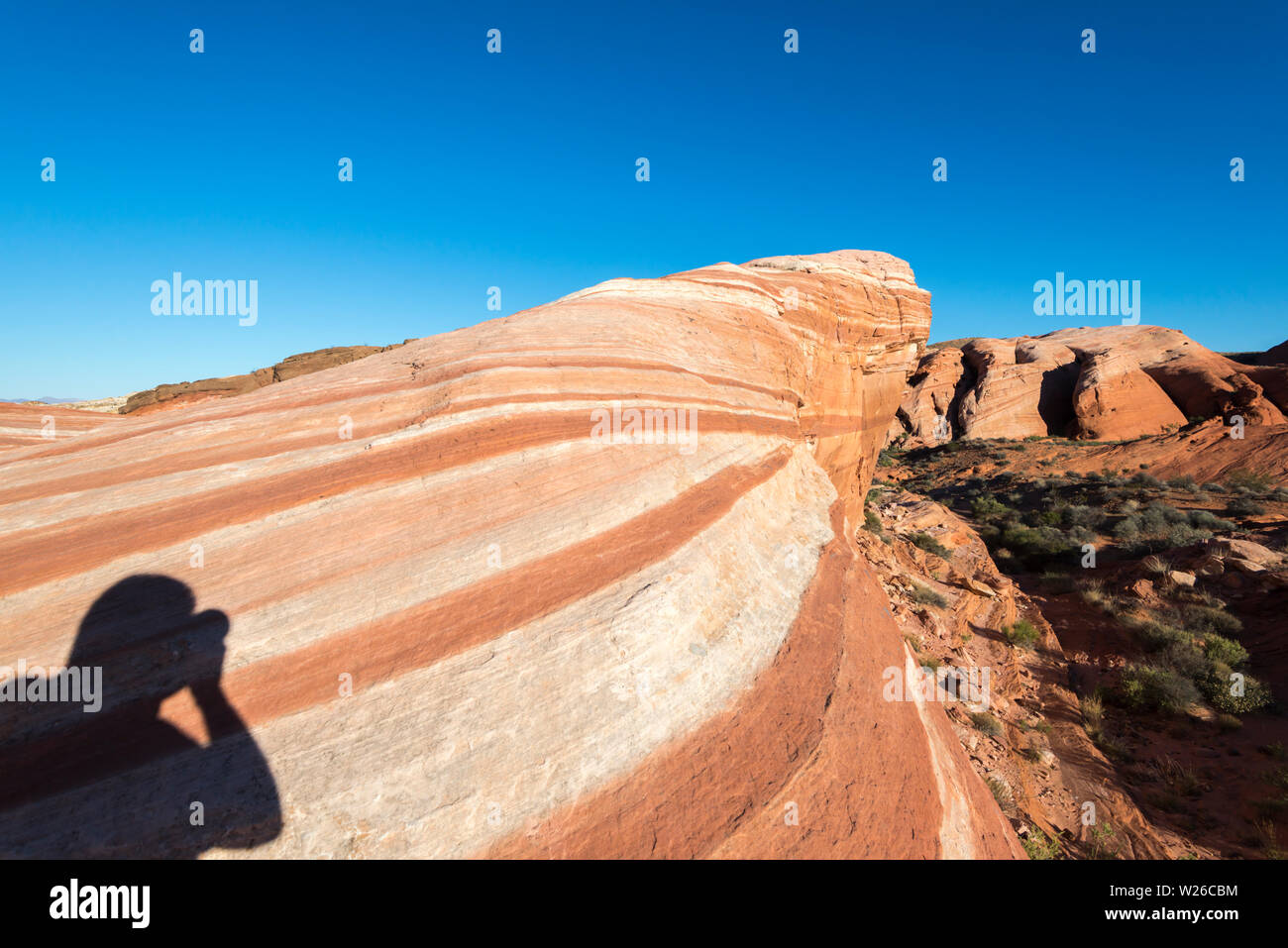 The Fire Wave rock formation with photographer's shadow. Valley of Fire ...