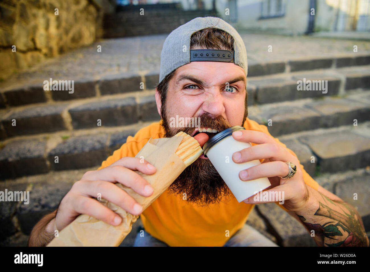 Snack for good mood. Guy eating hot dog. Street food concept. Man ...