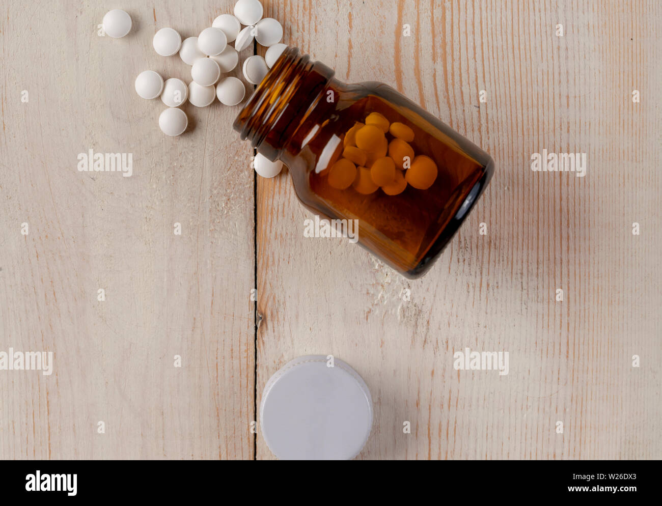 Glass and plastic bottles of medicine. Blue tablets and colored medical ...