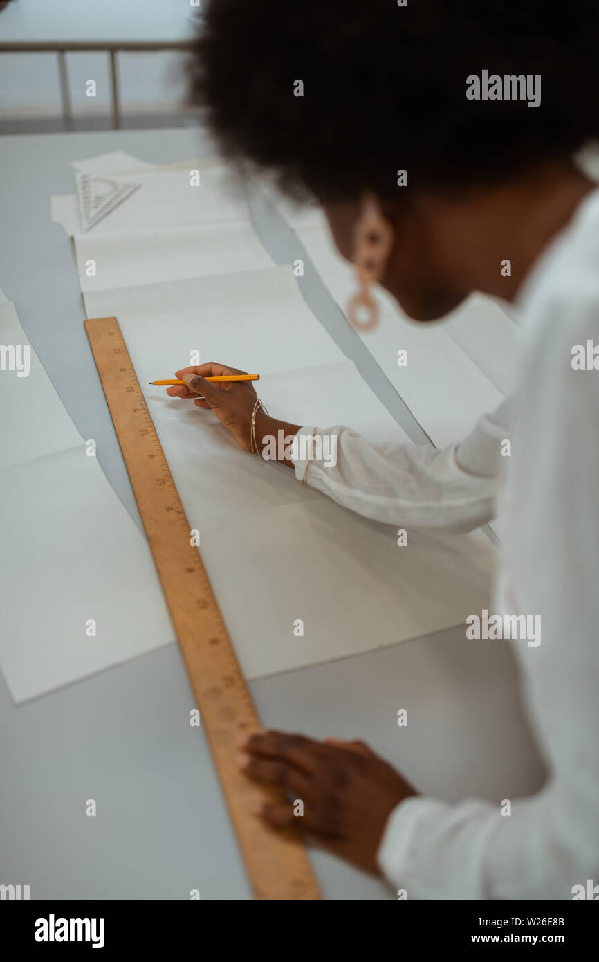 Sewing patterns. Back view portrait of an African American female ...