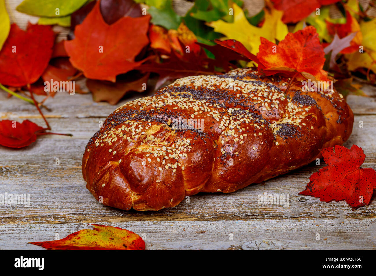 Bread is pieces yellow leaves. Wheat on autumn leaves as a background ...