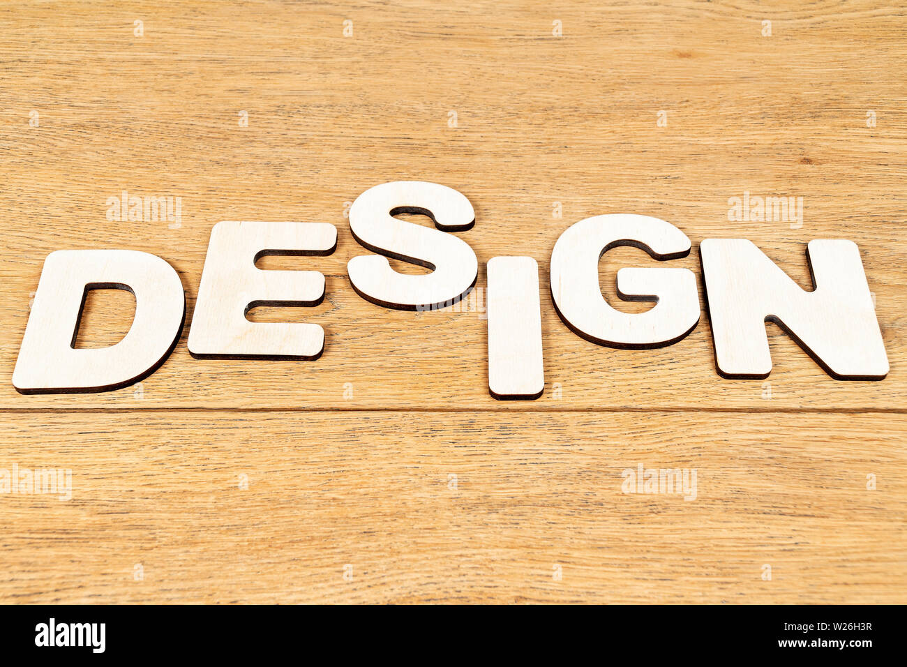 Word - design, laid out letters on an old wooden oak table Stock Photo ...