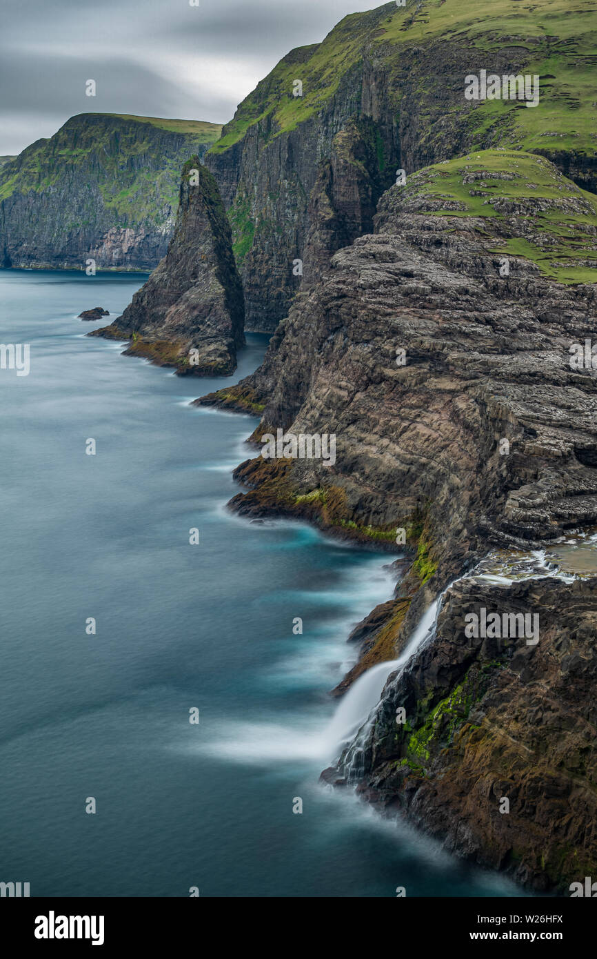 Bosdalafossur waterfall and coastline long exposure, vertical ...