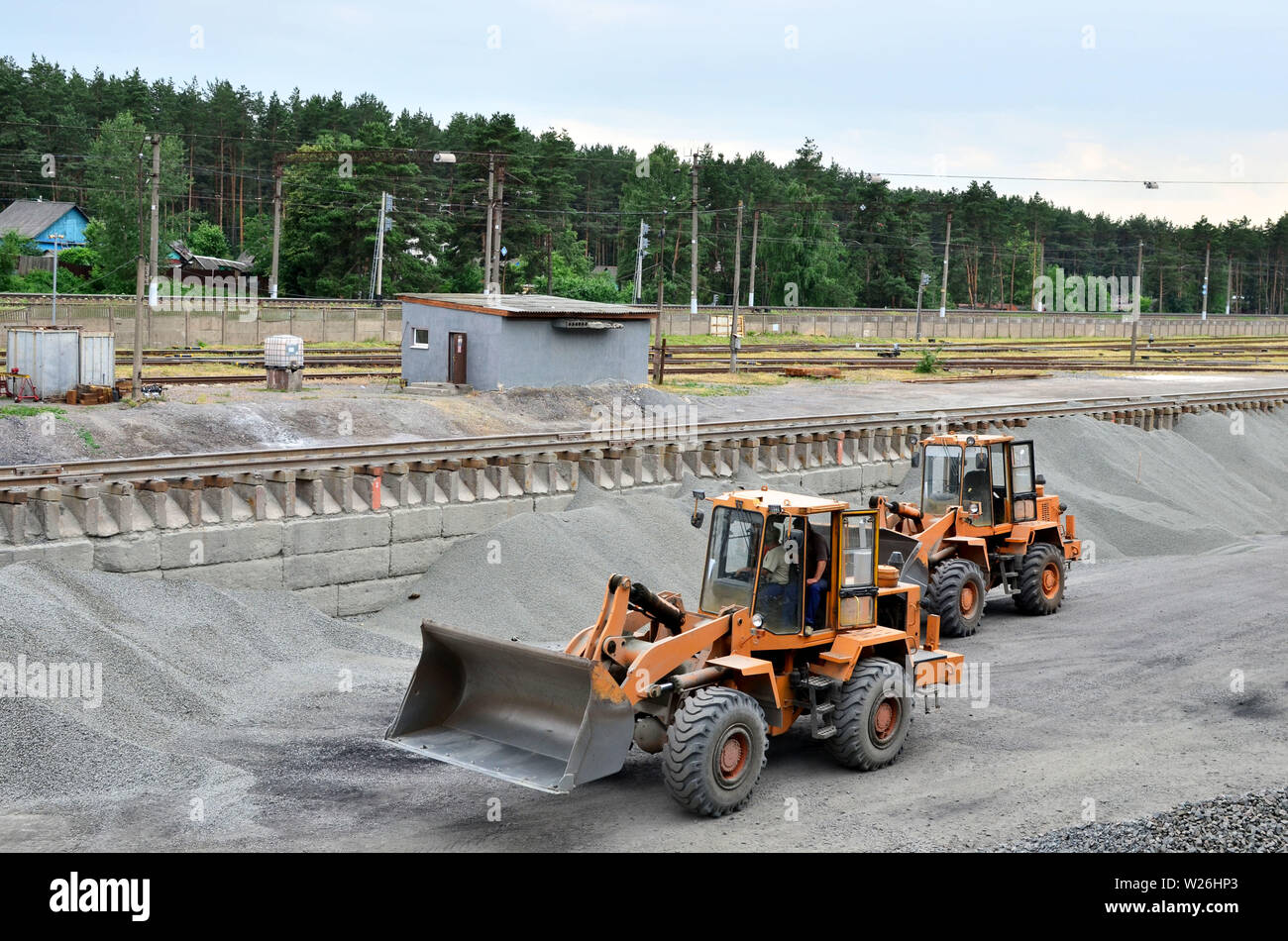 The wheel loader unloads crushed stone in a gravel pit. Unload bulk ...