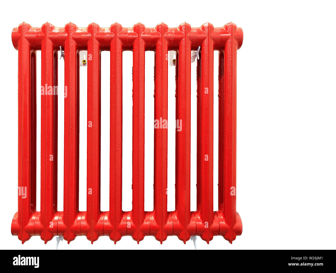 The old cast-iron heating radiator is painted with red paint and is ...