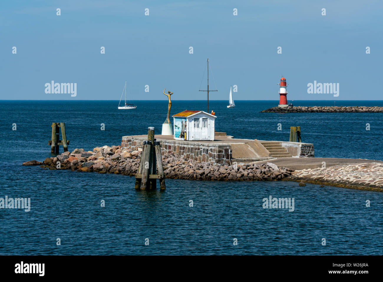 middle pier in Warnemuende to welcome ships with red beacon in the ...