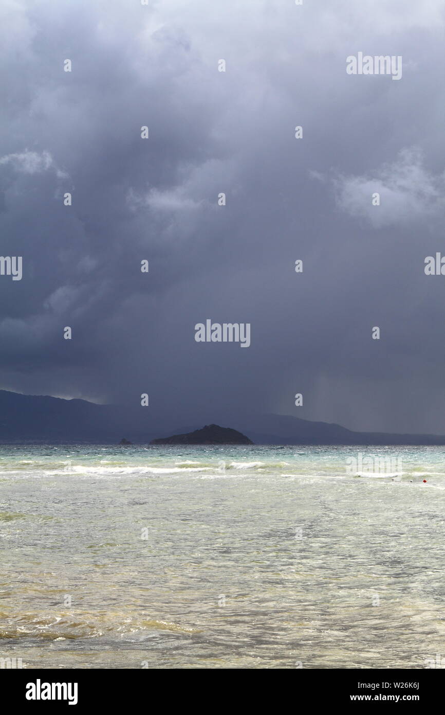 Heavy, storm clouds over the ocean, herald the arrival of a storm ...