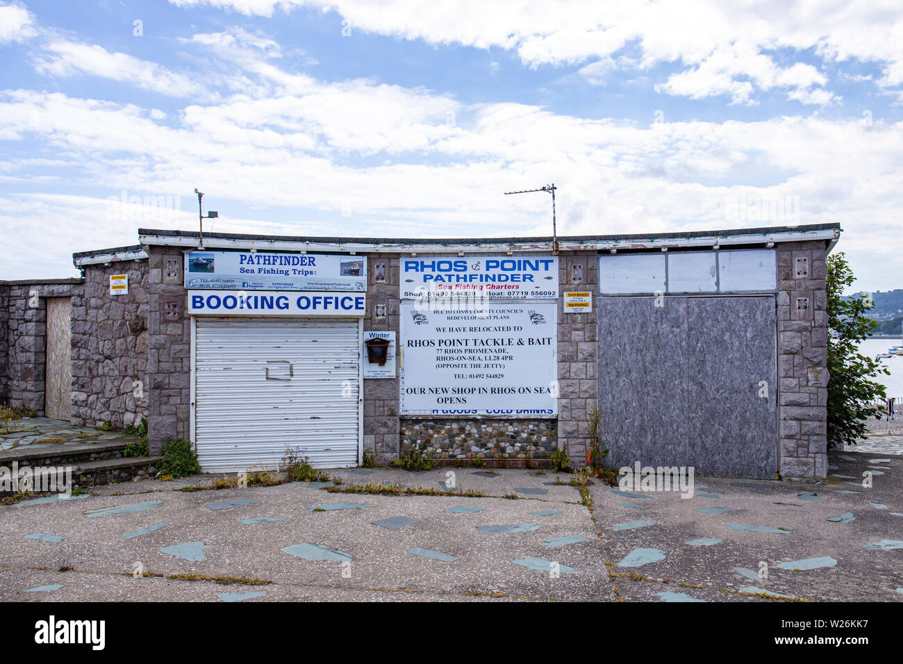 Closed down and boarded up Rhos Point shops in Rhos-on-Sea Conwy Wales ...