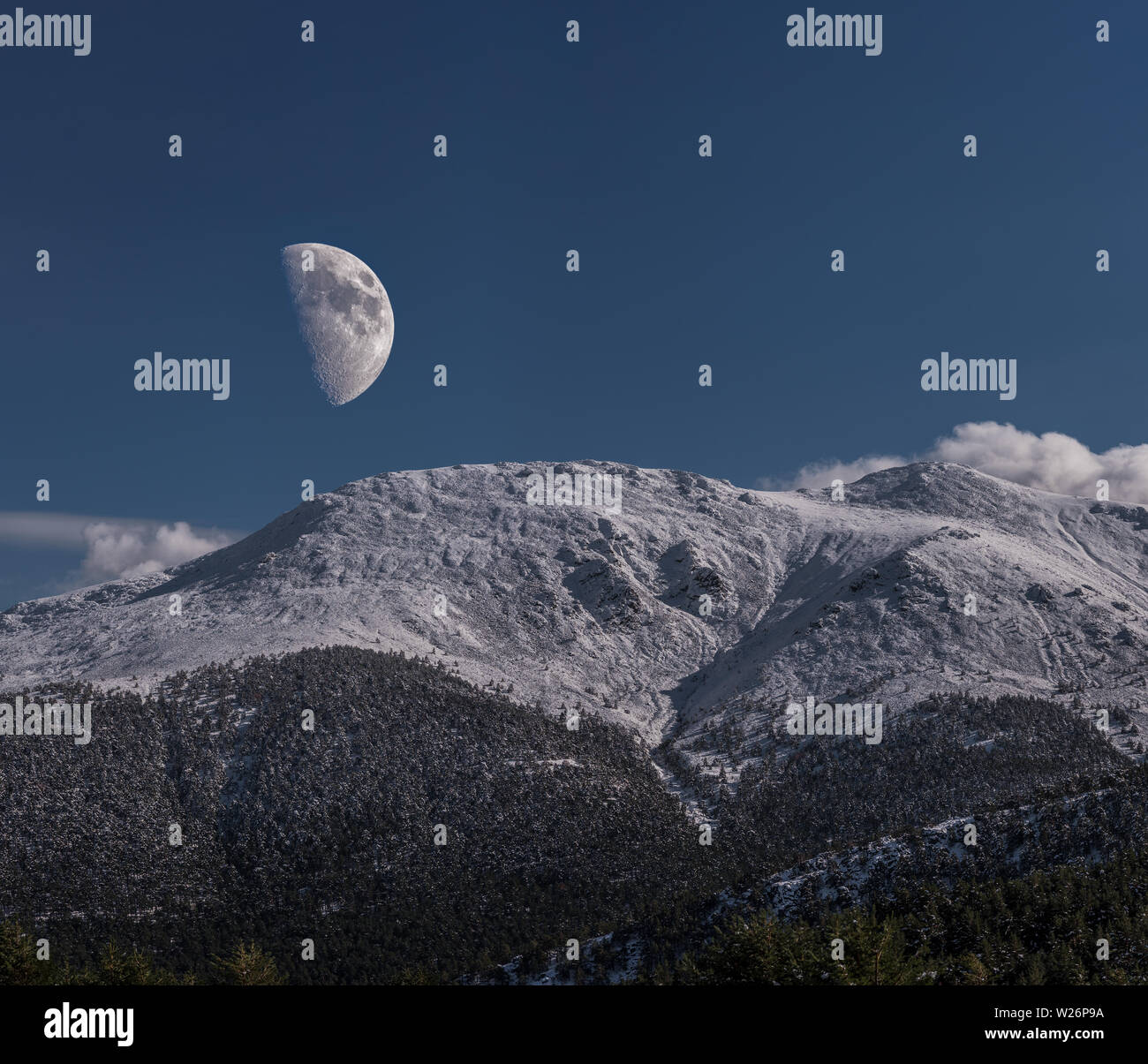 Snowy mountains with blue sky and the moon Stock Photo - Alamy