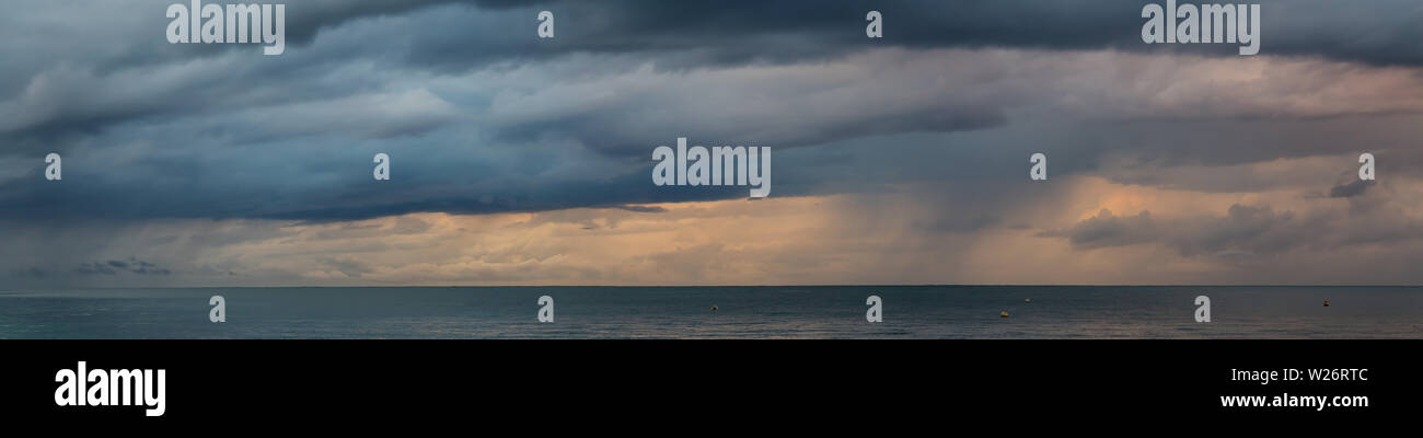 Dramatic View of a cloudscape over the Ocean during a dark, rainy and ...