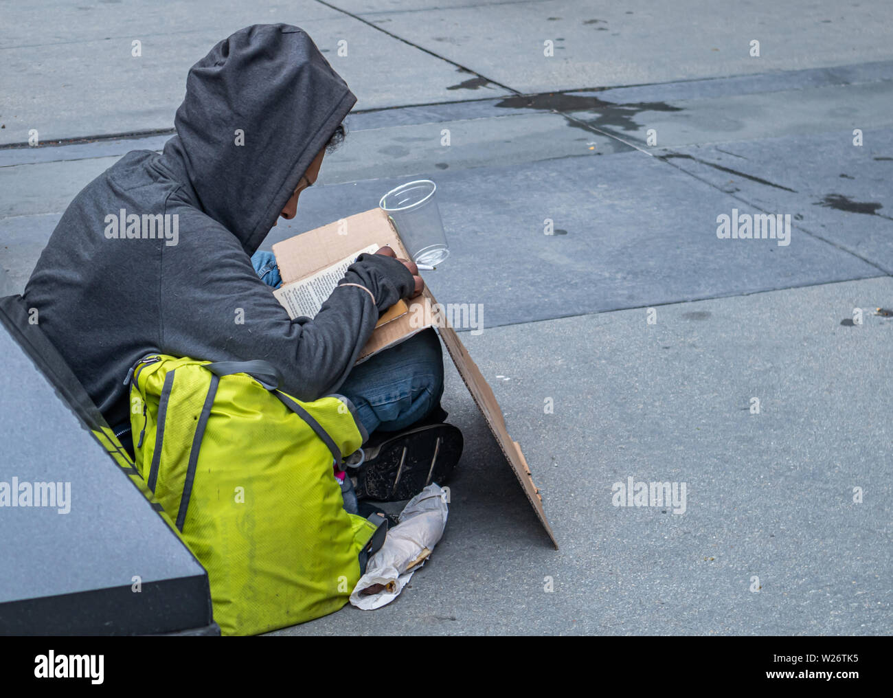 USA, Chicago, Illinois. May 9, 2019. Homeless sitting on the roadside ...
